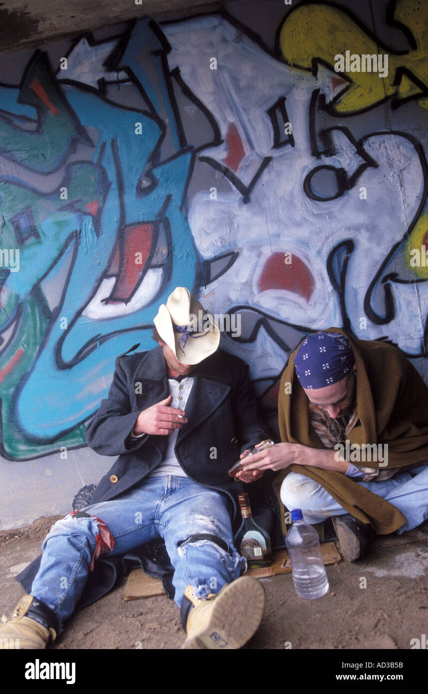 Derelicts in drunken stupor amidst grafitti Stock Photo - Alamy
