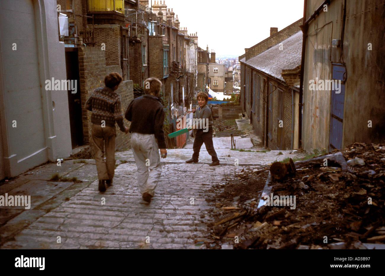 Two boys playing truant trying to bully a younger kid Stock Photo - Alamy