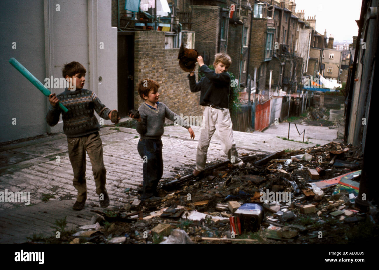 Kids playing in a run down street with rubble Stock Photo - Alamy