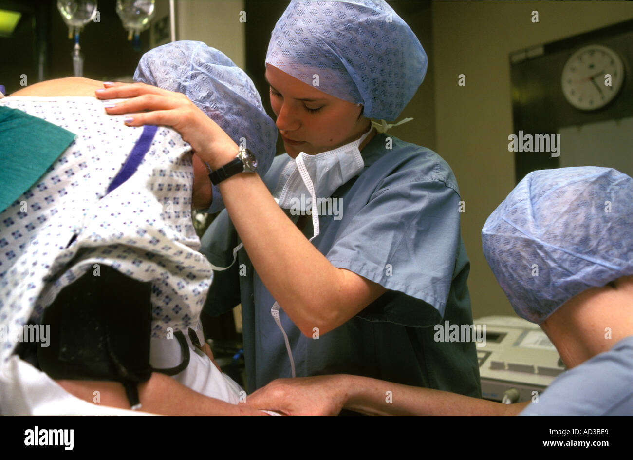 Patient comforted while being anaesthetic epidural injection Stock ...