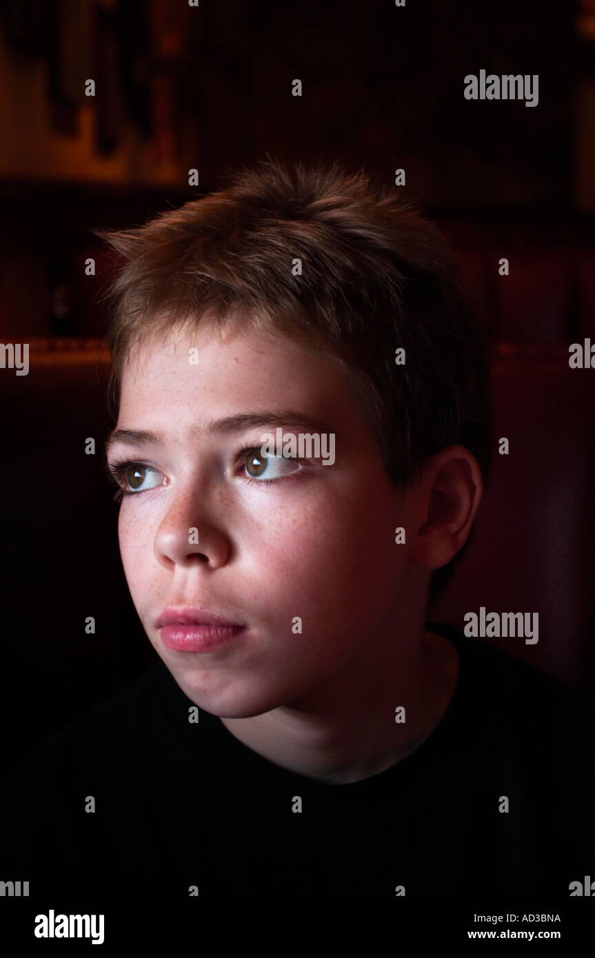 Young boy lit by window light Stock Photo - Alamy