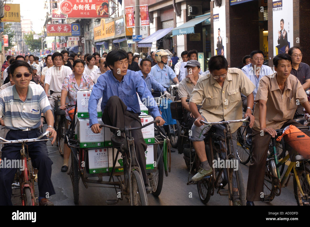 Rush hour commuters on bicycles in the centre of Shanghai China Stock ...