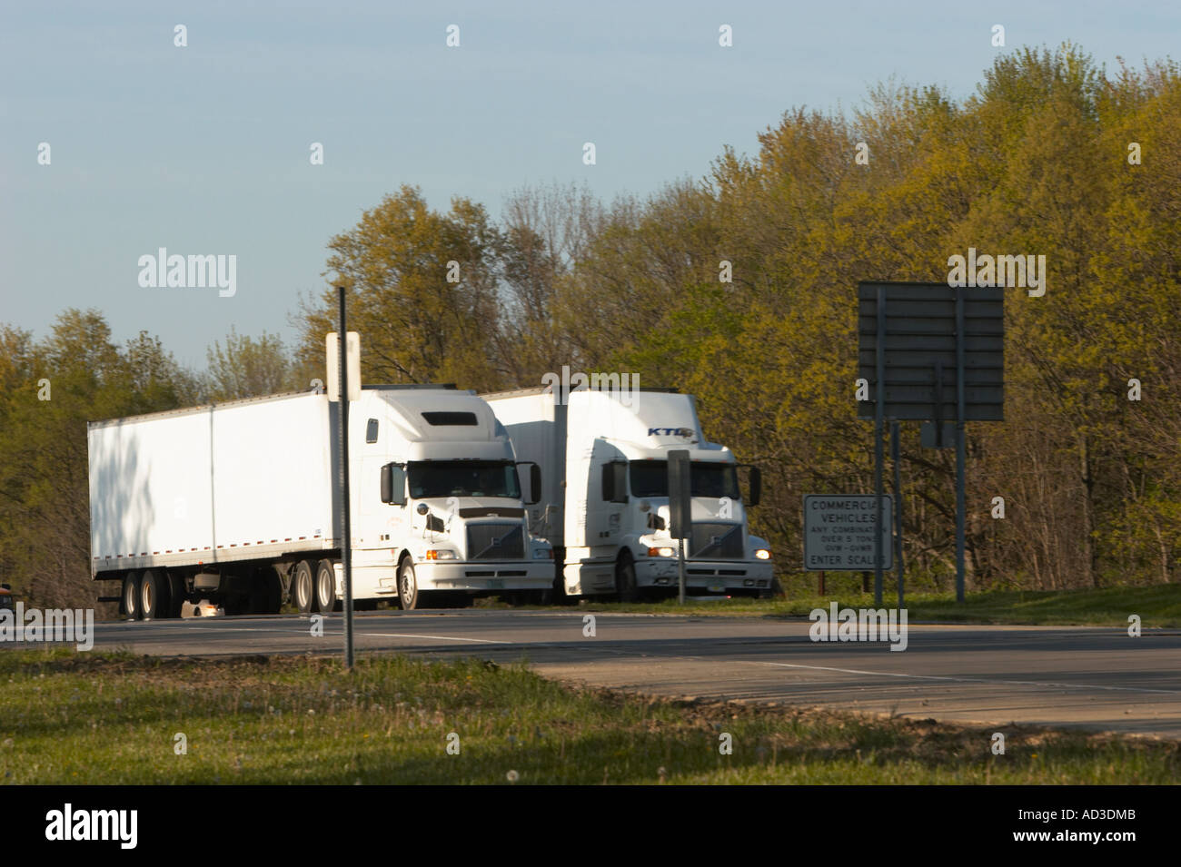 Two semi trucks traveling down the highway Stock Photo - Alamy