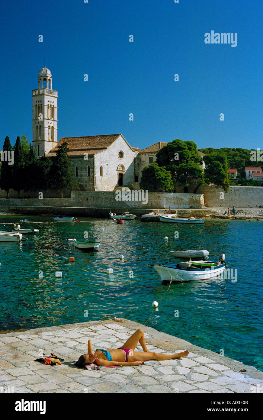 Girl sunbathing woman holiday resort tanning hvar island hi-res stock ...