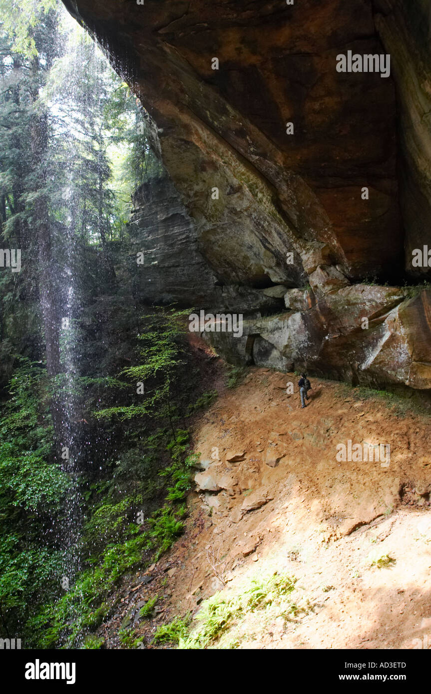 Water falling off a rock face is lit by sunlight Stock Photo - Alamy