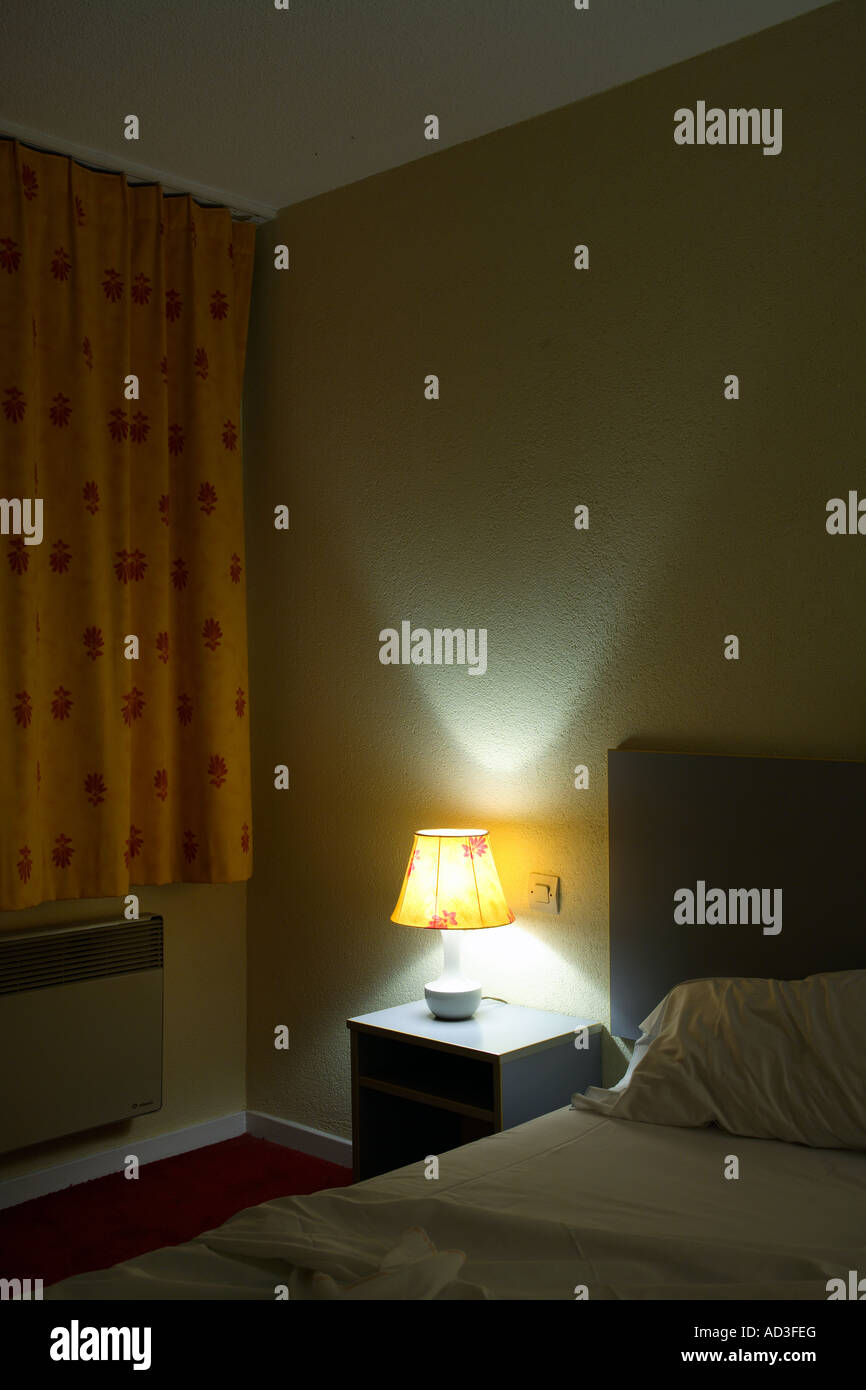 empty motel room with bed and lamp at night Stock Photo - Alamy