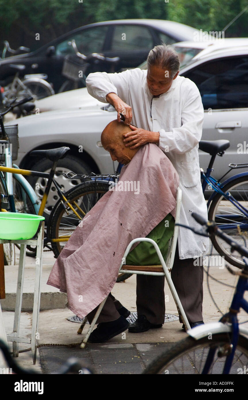 an outdoor barber shop in a residential estate Beijing China Stock ...