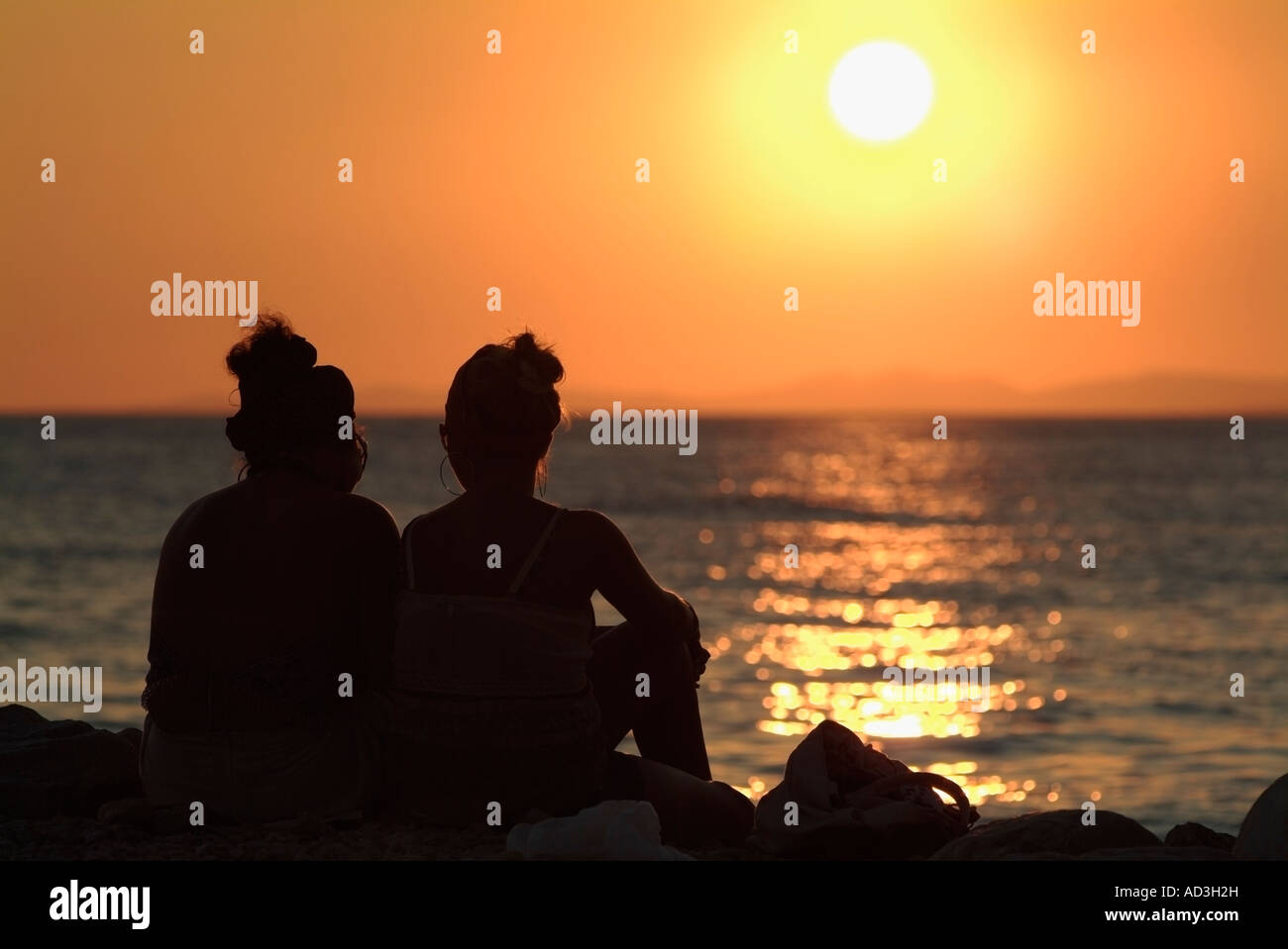 Silhouette two women watching sunset hi-res stock photography and ...