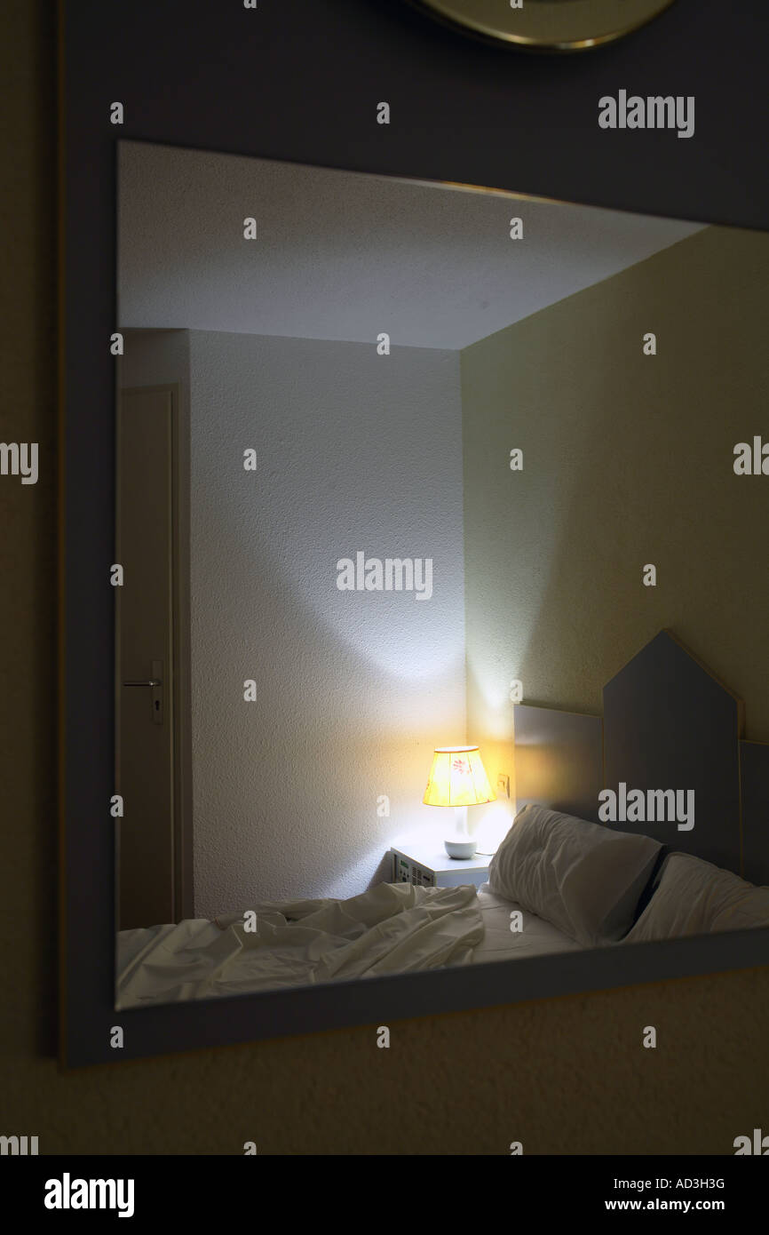 empty motel room with bed and lamp at night Stock Photo - Alamy