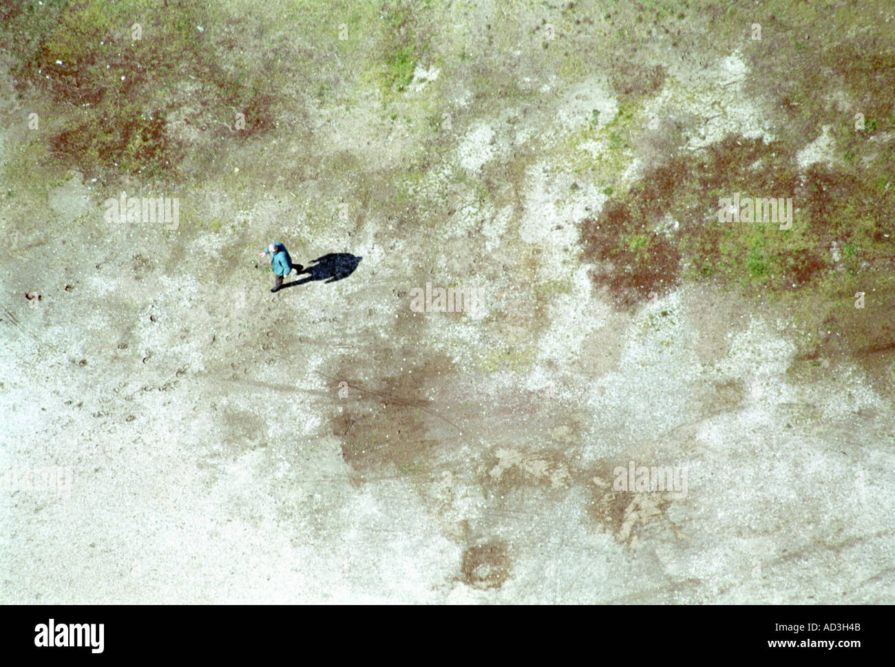 aerial view of man walking on white gravel Stock Photo - Alamy