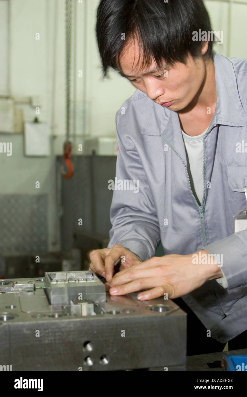 Chinese Metal Worker prepares mold in Machine Tools Room of High Tech ...