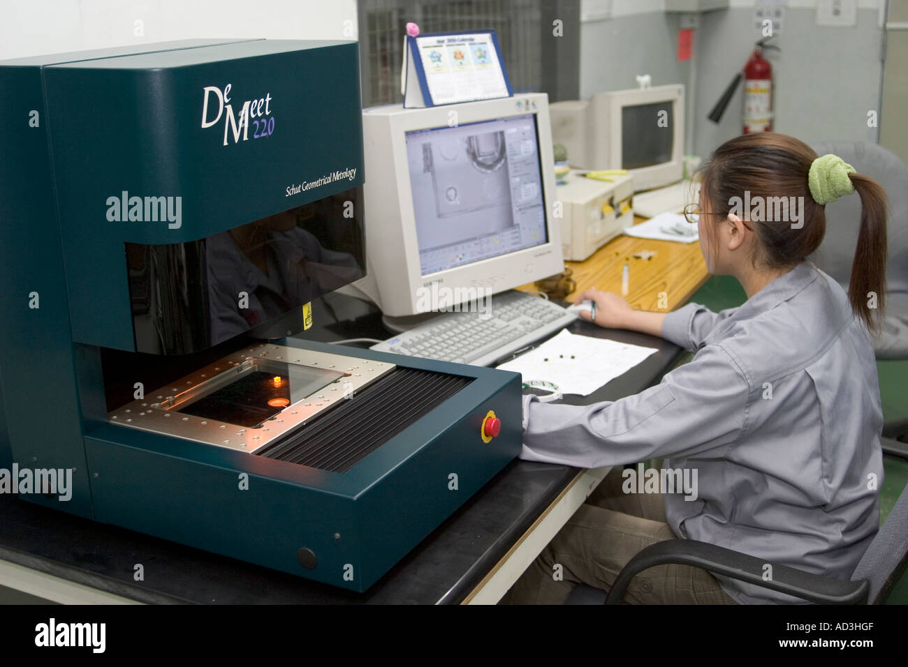 Chinese Worker with Precision measuring device in high tech factory ... Chinese Worker with Precision measuring device in high tech factory ...