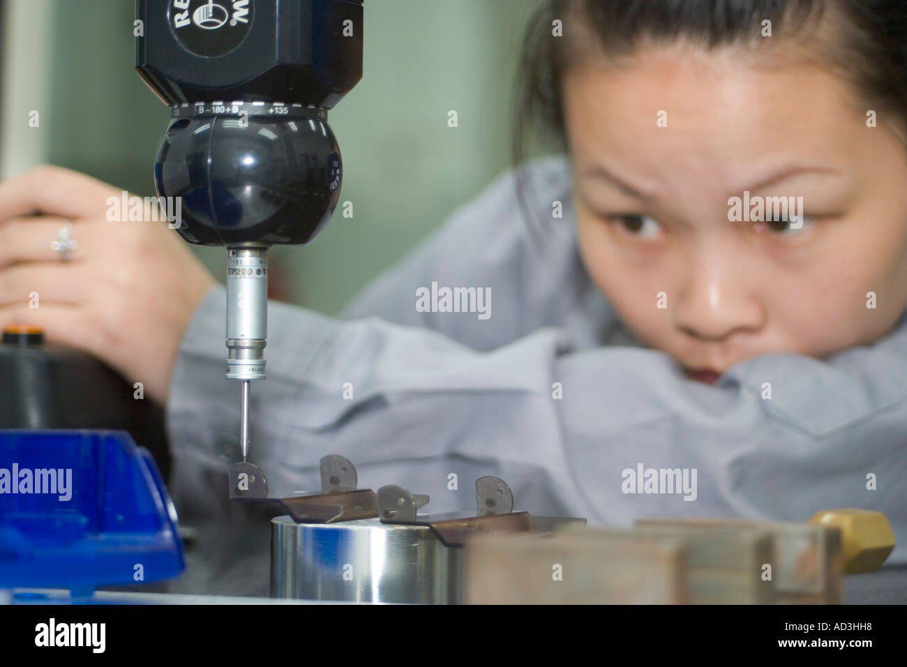 Chinese Worker with Precision measuring device in high tech factory ... Chinese Worker with Precision measuring device in high tech factory ...