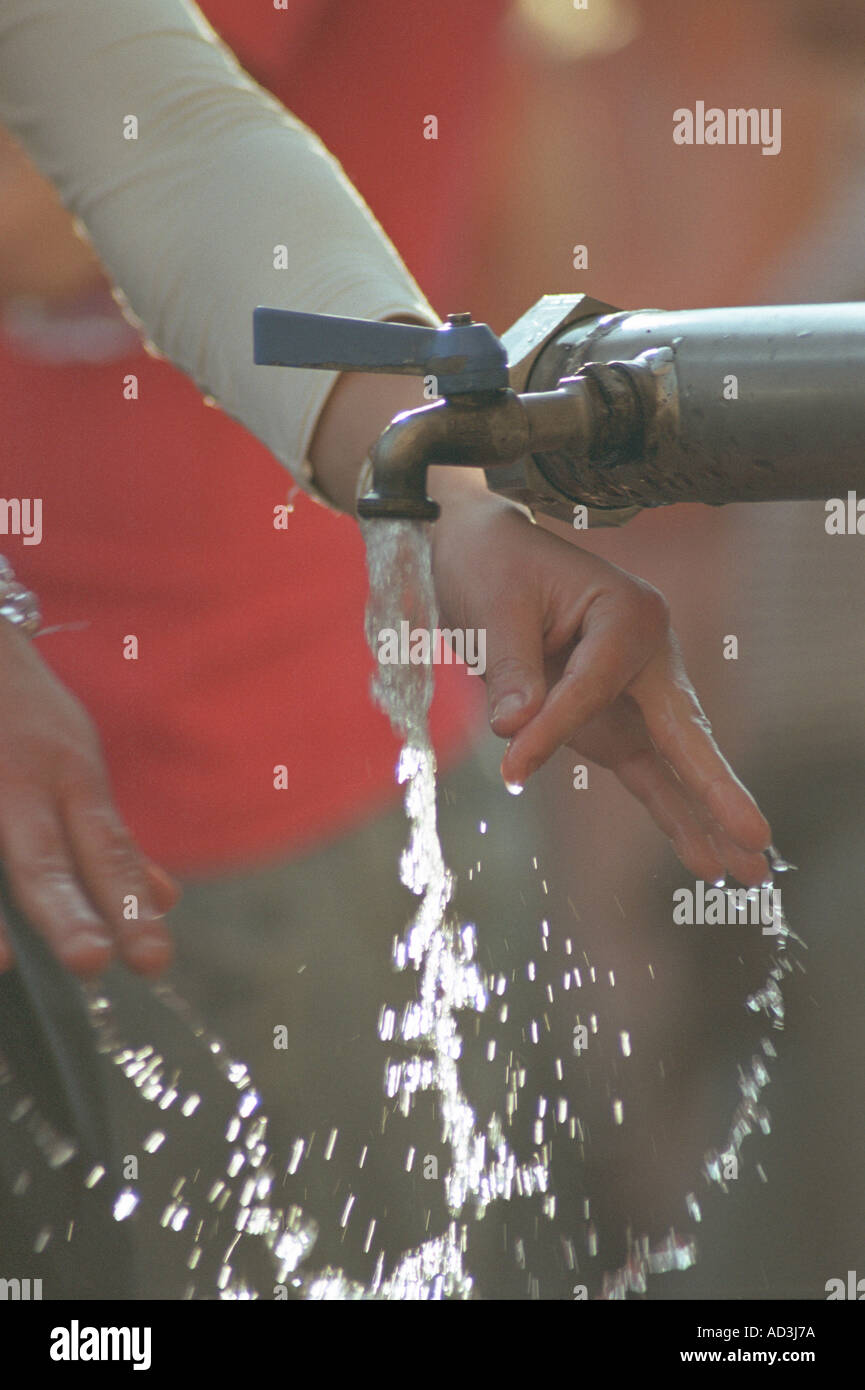 washing hands under running tap water Stock Photo - Alamy