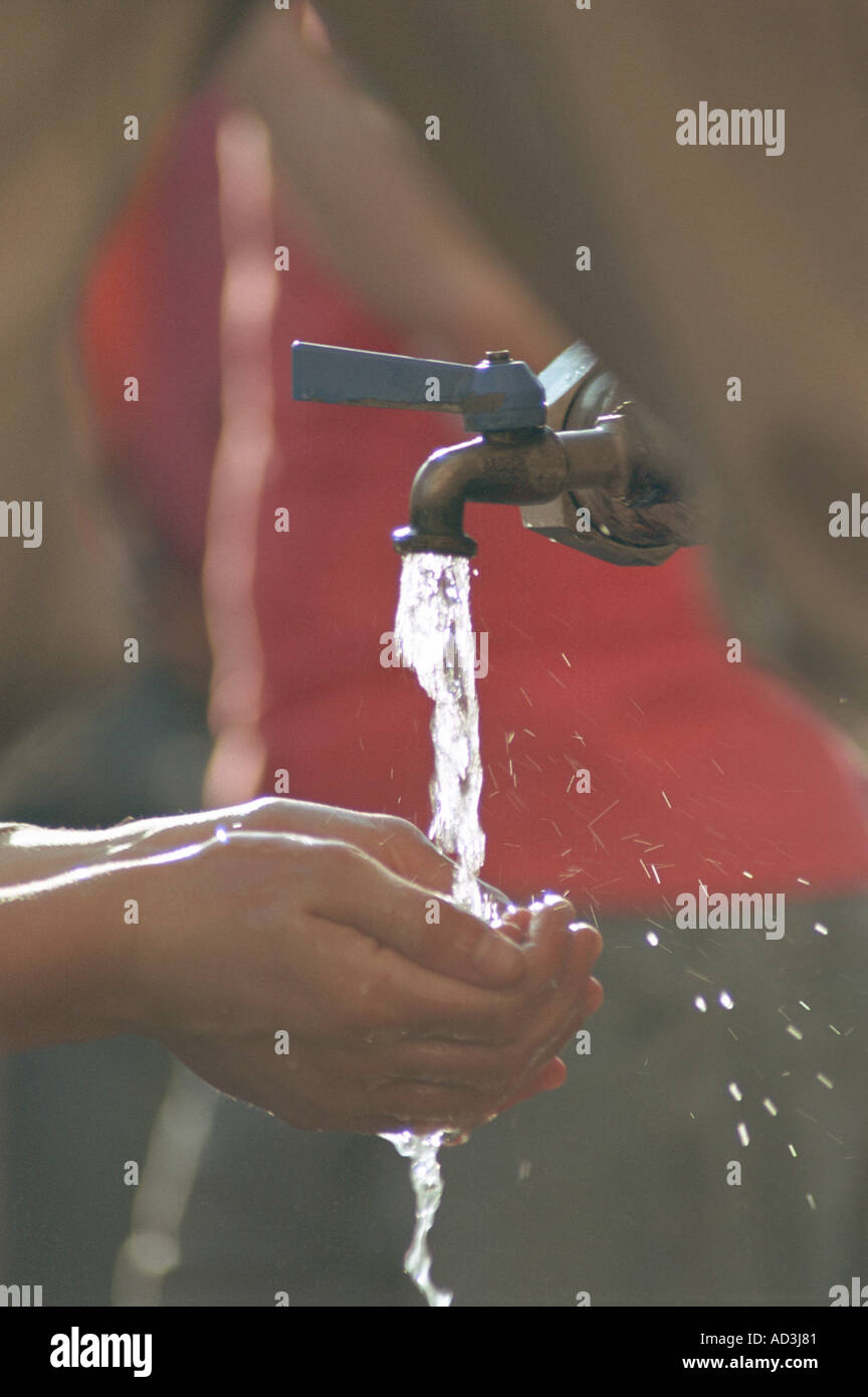 washing hands under running tap water Stock Photo - Alamy