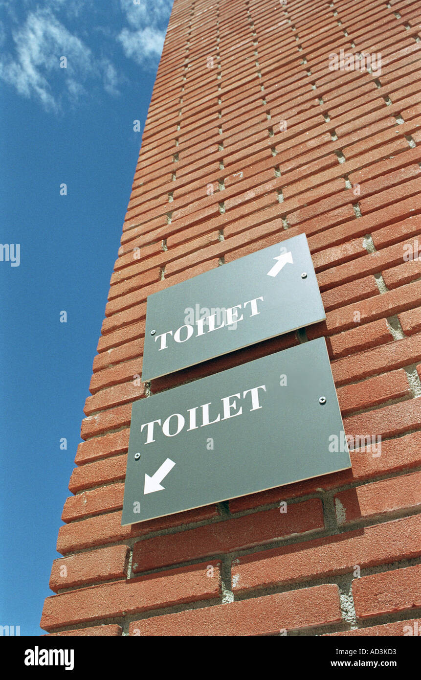 two toilet signs on brick wall Stock Photo - Alamy
