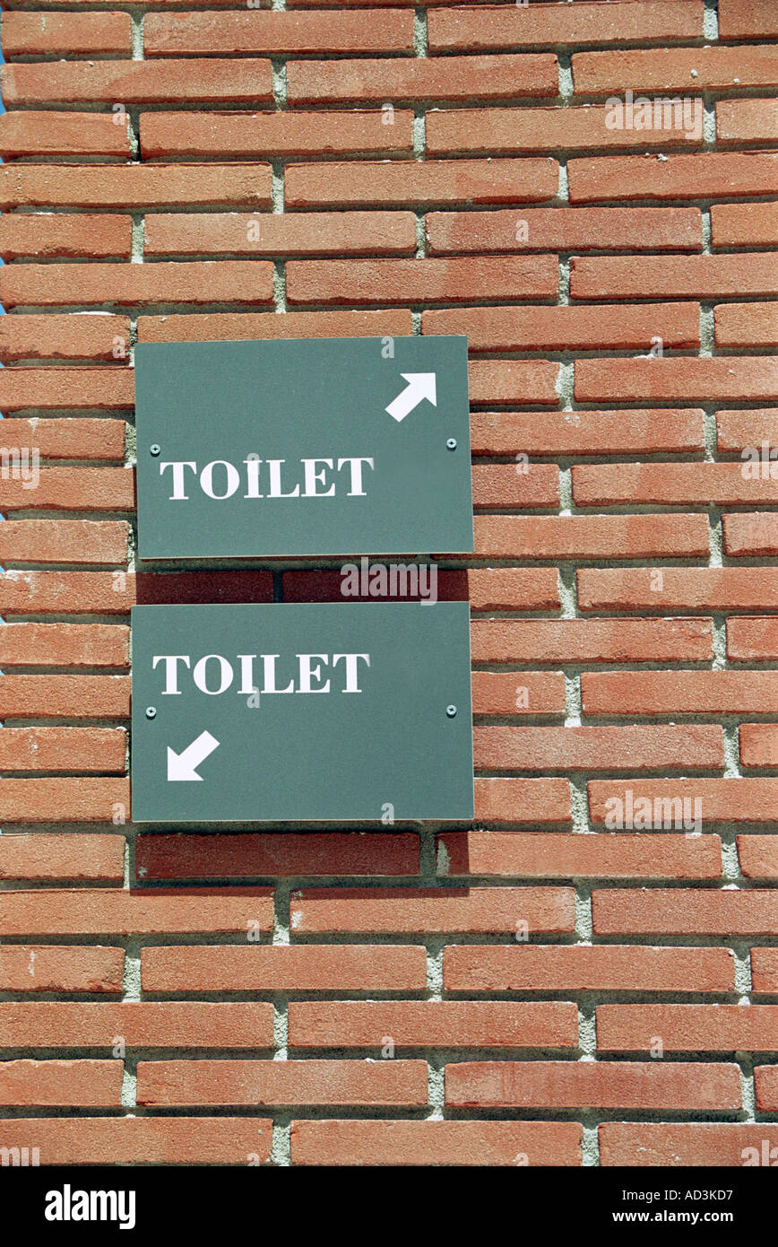 two toilet signs on brick wall Stock Photo - Alamy