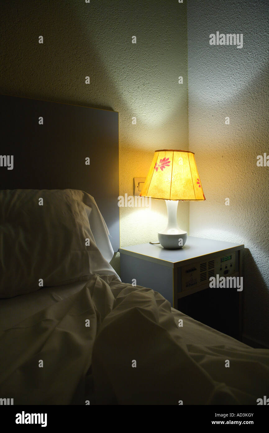 empty motel room with bed and lamp at night Stock Photo - Alamy