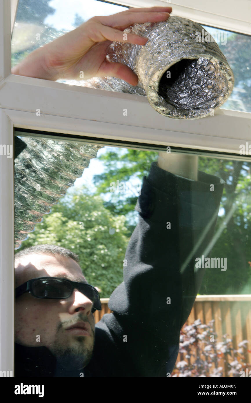 Man Placing Gas Pipe in Window Model Released Stock Photo - Alamy