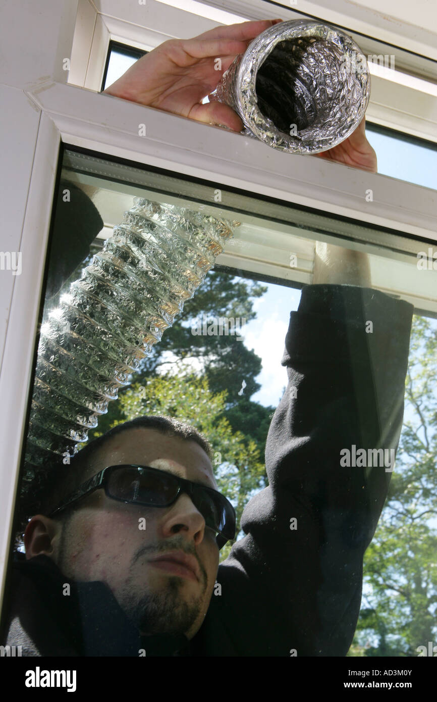 Man Placing Gas Pipe in Window Model Released Stock Photo - Alamy
