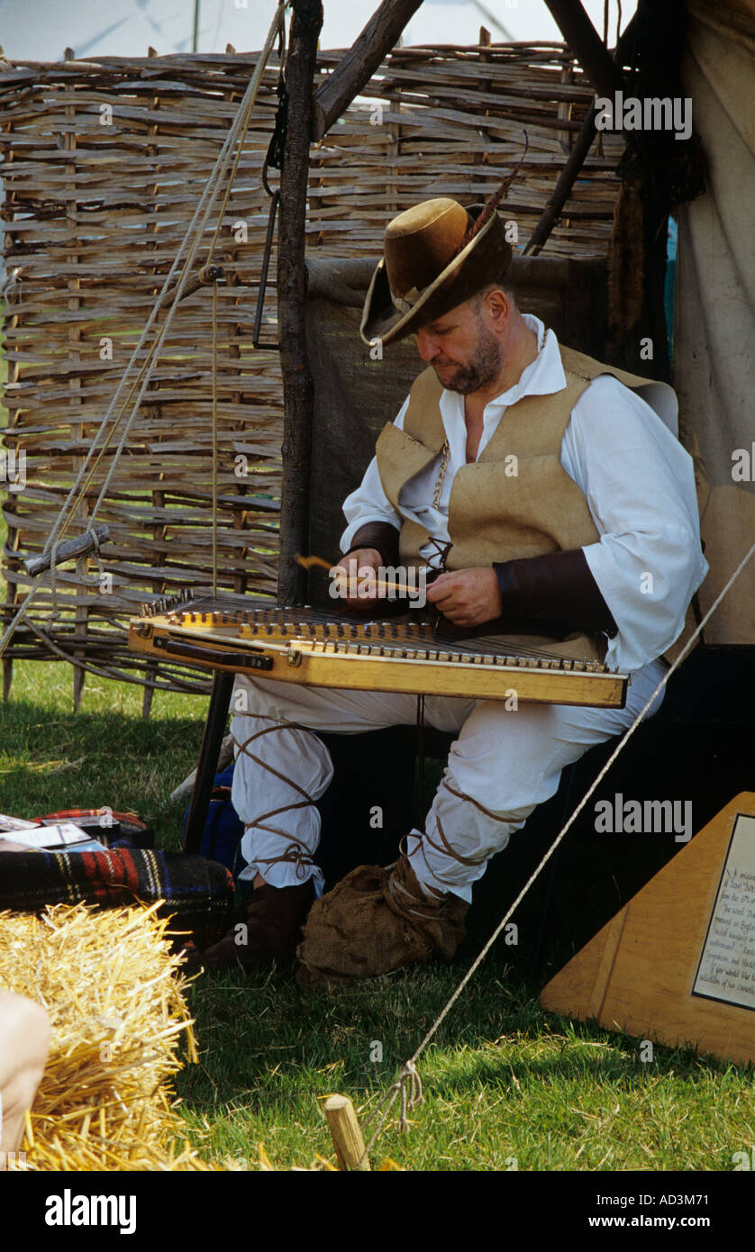 HAMPSHIRE UK July Musician playing a hammered dulcimer an ancient ...
