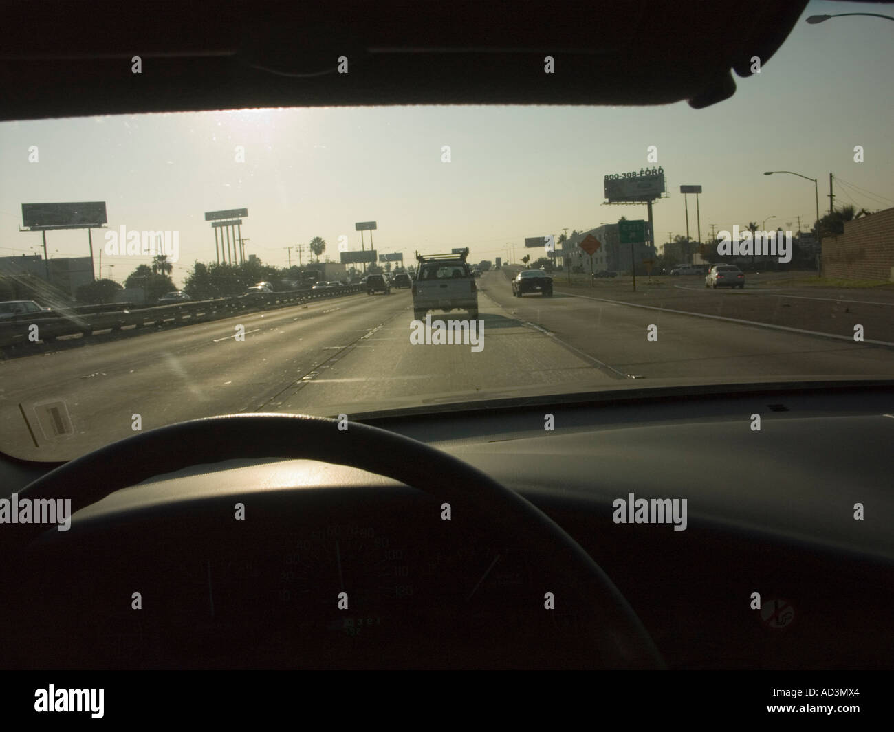 Highway travel from inside car passing downtown buildings Stock Photo ...