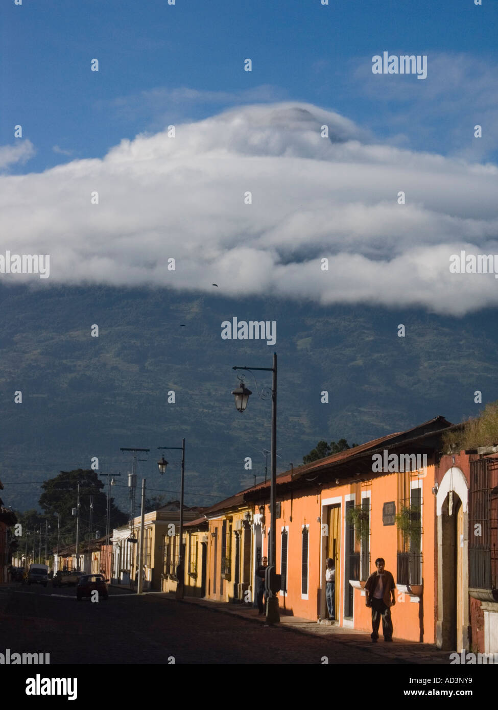 Colonial Spanish buildings facades with bright colors beneath a volcano ...