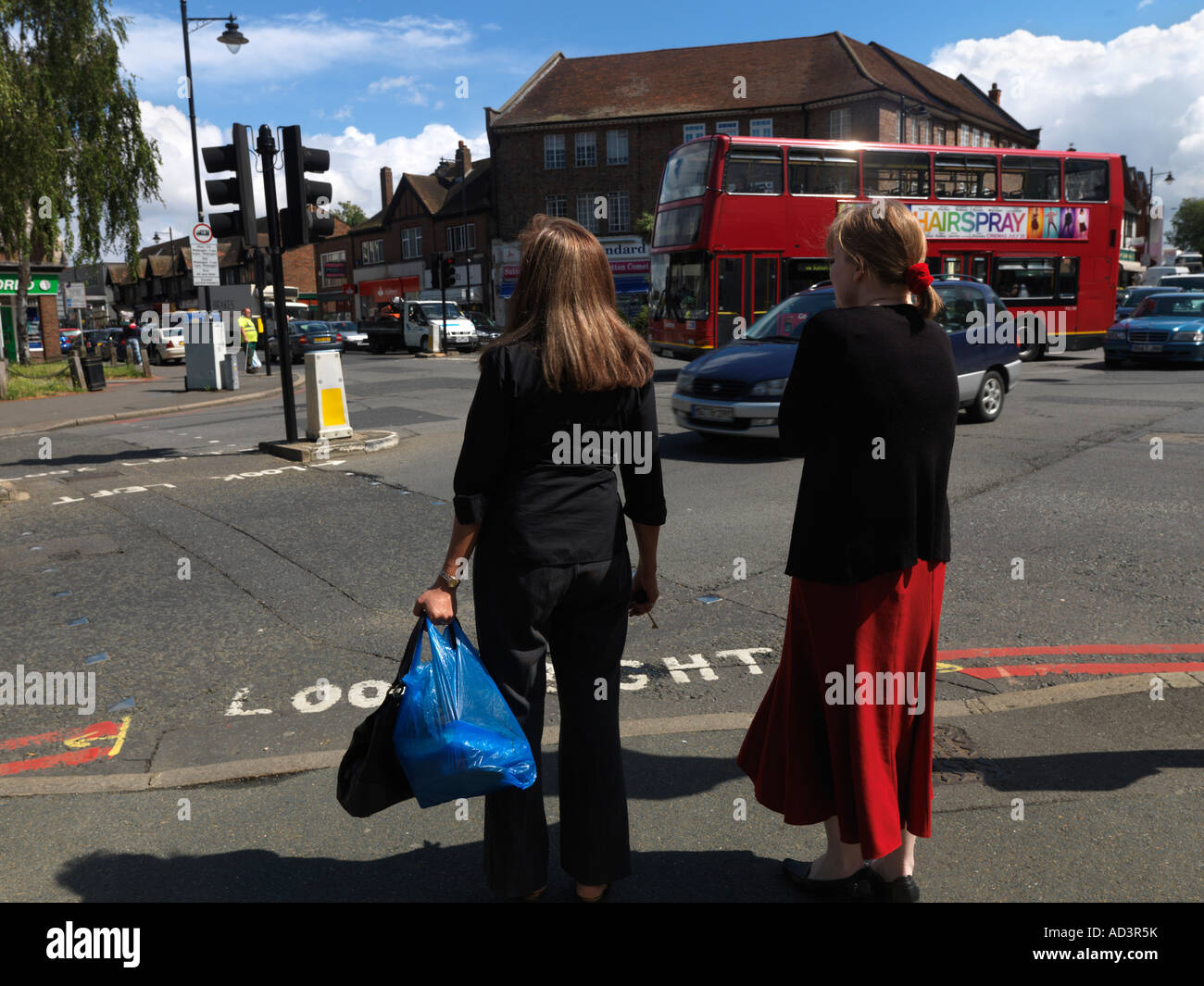 Two teenagers crossing the road hi-res stock photography and images - Alamy