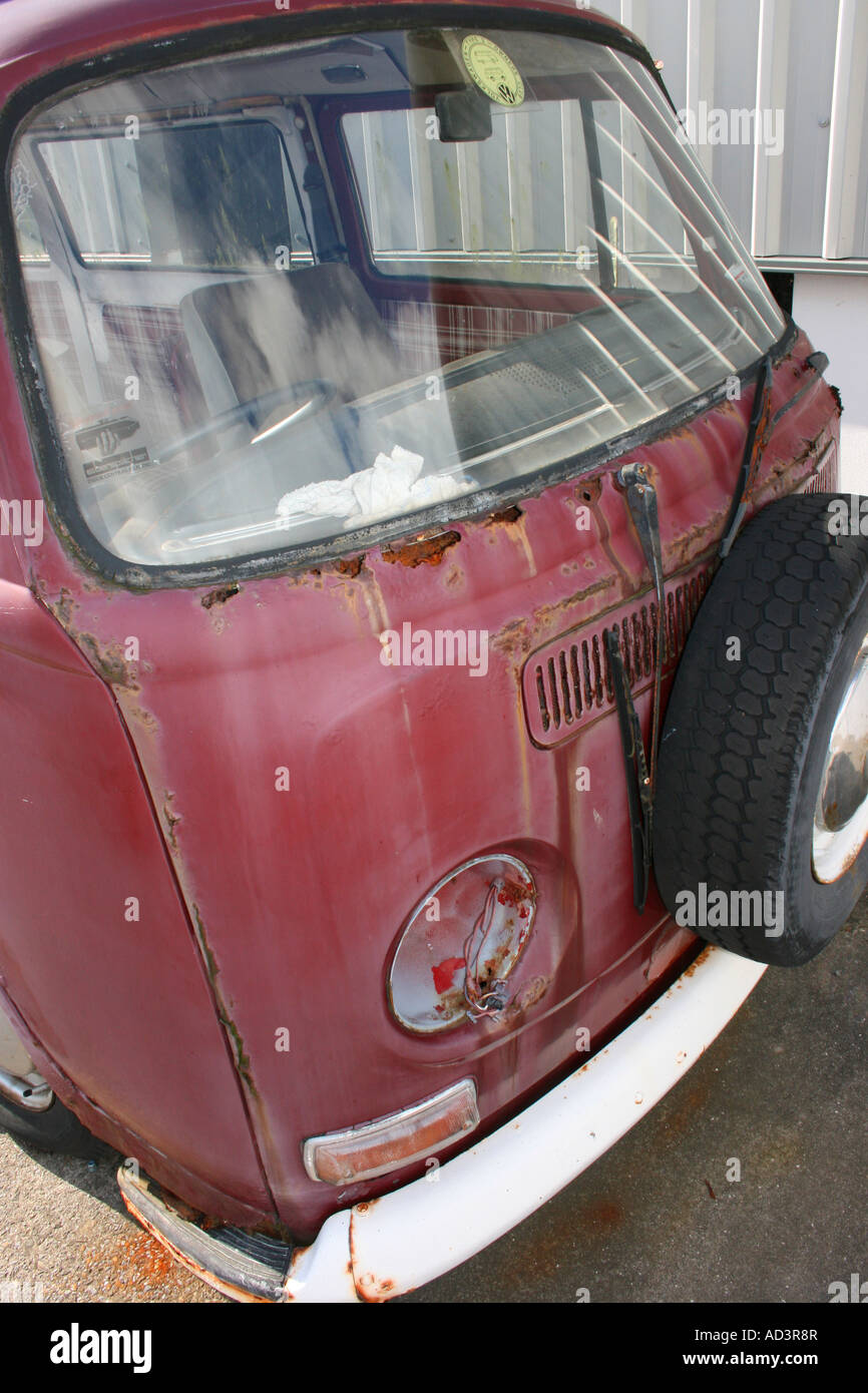 Beaten up old Volkswagen camper parked at old garage buildings ...