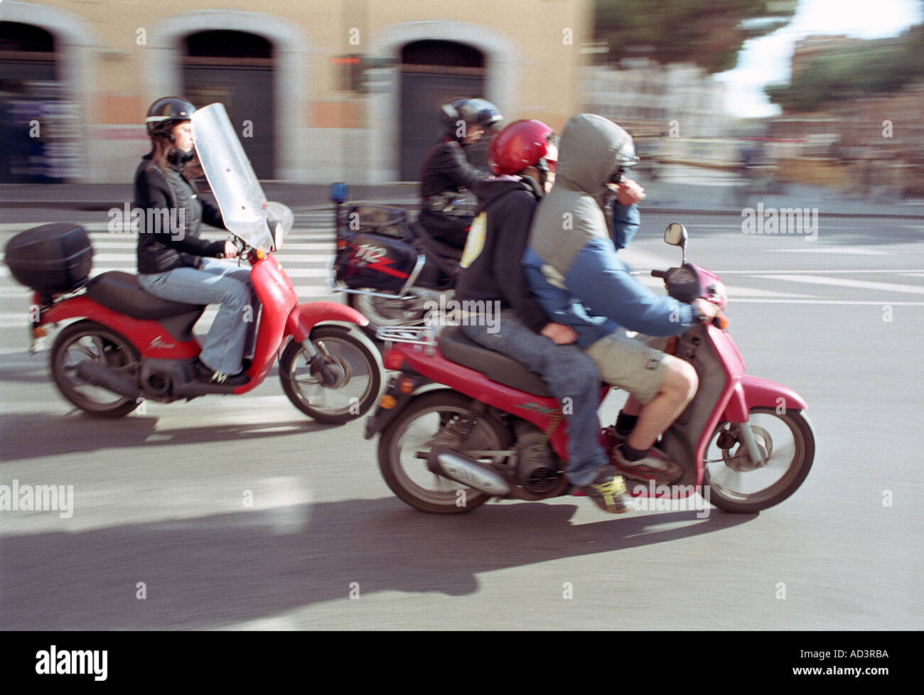 mopeds speeding by in winter rome movement Stock Photo - Alamy
