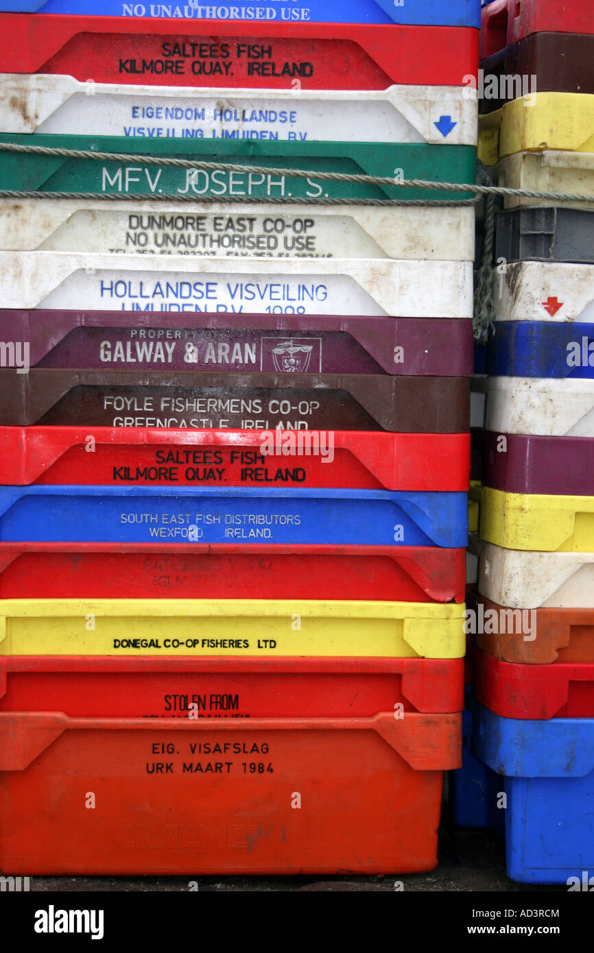 colourful fish boxes on the quayside at Rush harbour, County Dublin ...