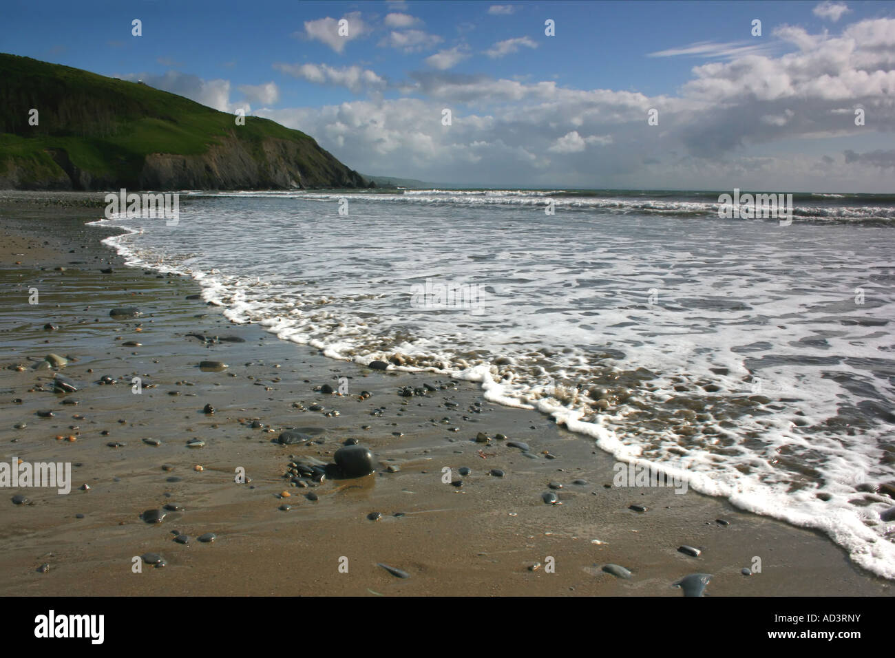 Waves rolling onto the beach at Clarach Bay near Aberystwyth, Wales ...