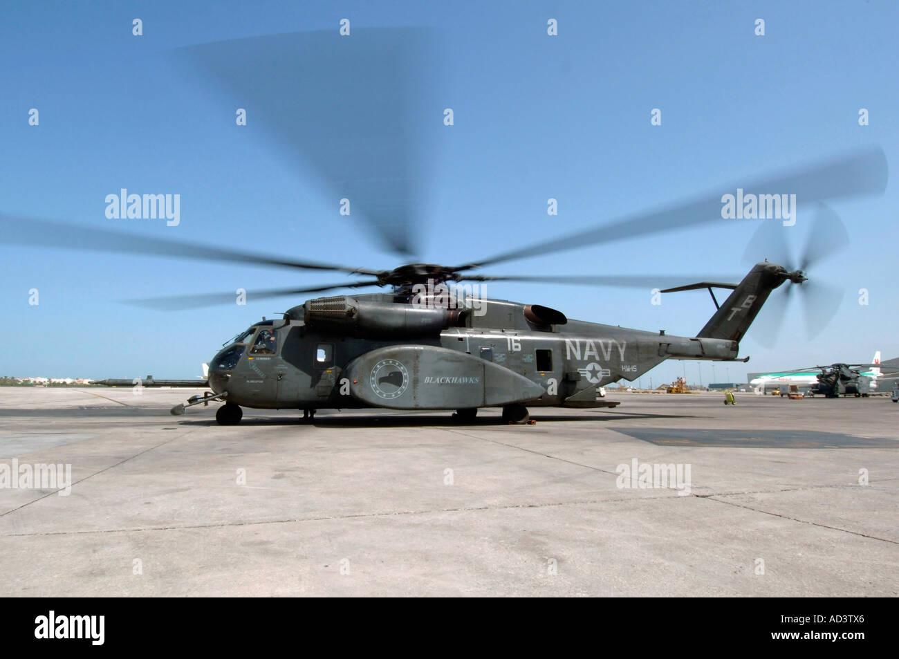 An MH-53E Sea Dragon helicopter sits ready on the flight line for a ...