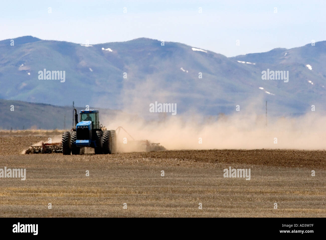 Farm tractor disking field in camas County Idaho Stock Photo - Alamy