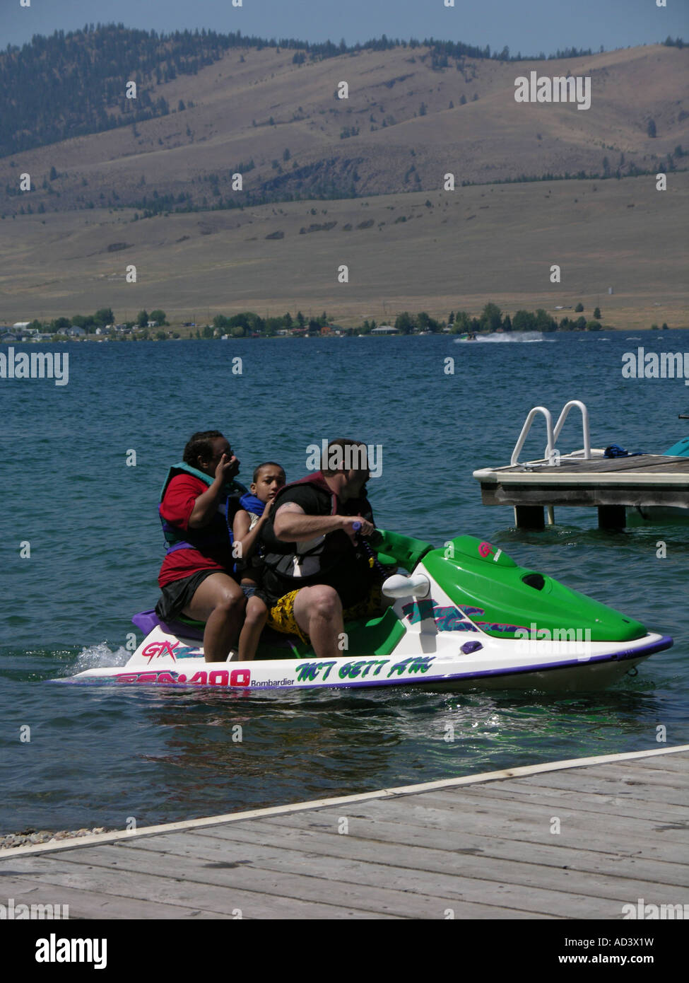 Family riding jet ski Stock Photo - Alamy