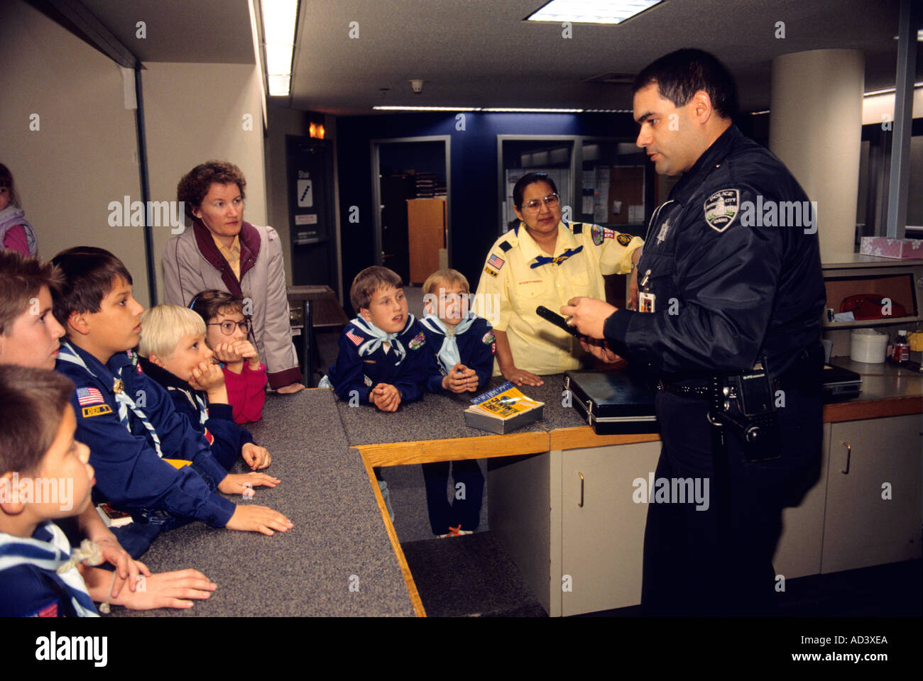 A police officer speaks to cub Scouts on a field trip to a police ...