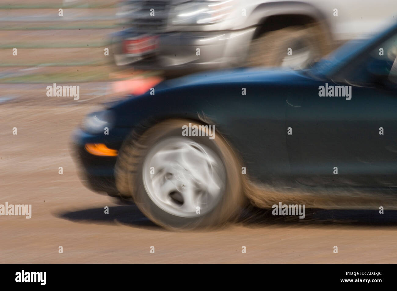 Vehicle wheels turning on dirt Stock Photo - Alamy