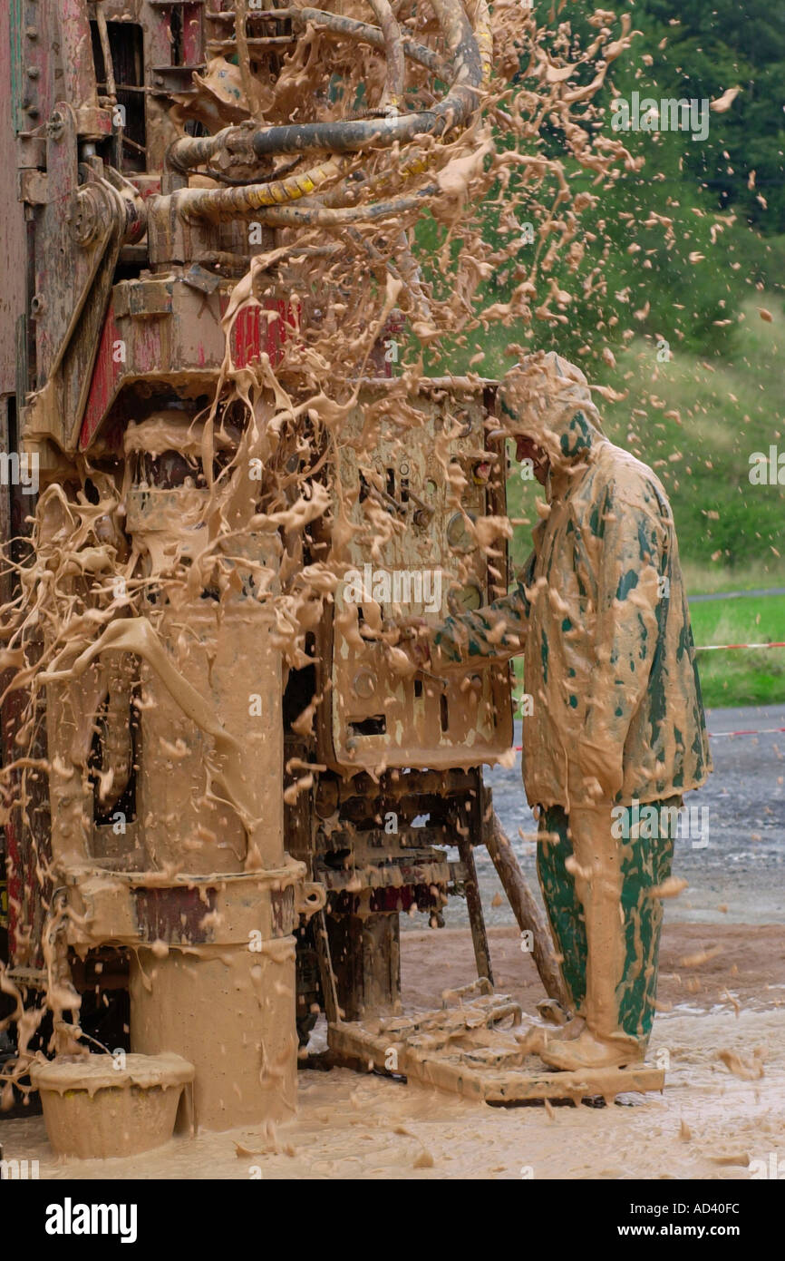 Engineer covered in foam and mud while drilling for water at Gwalia ...