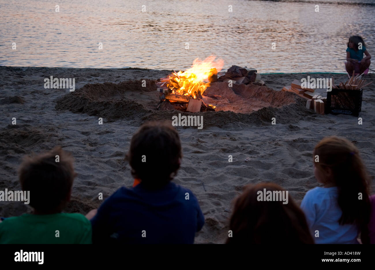 Children sitting around a campfire Stock Photo - Alamy