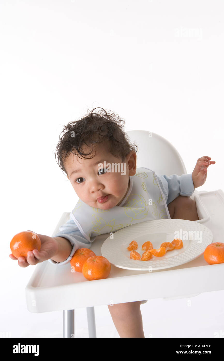 Little boy with mandarin Stock Photo - Alamy