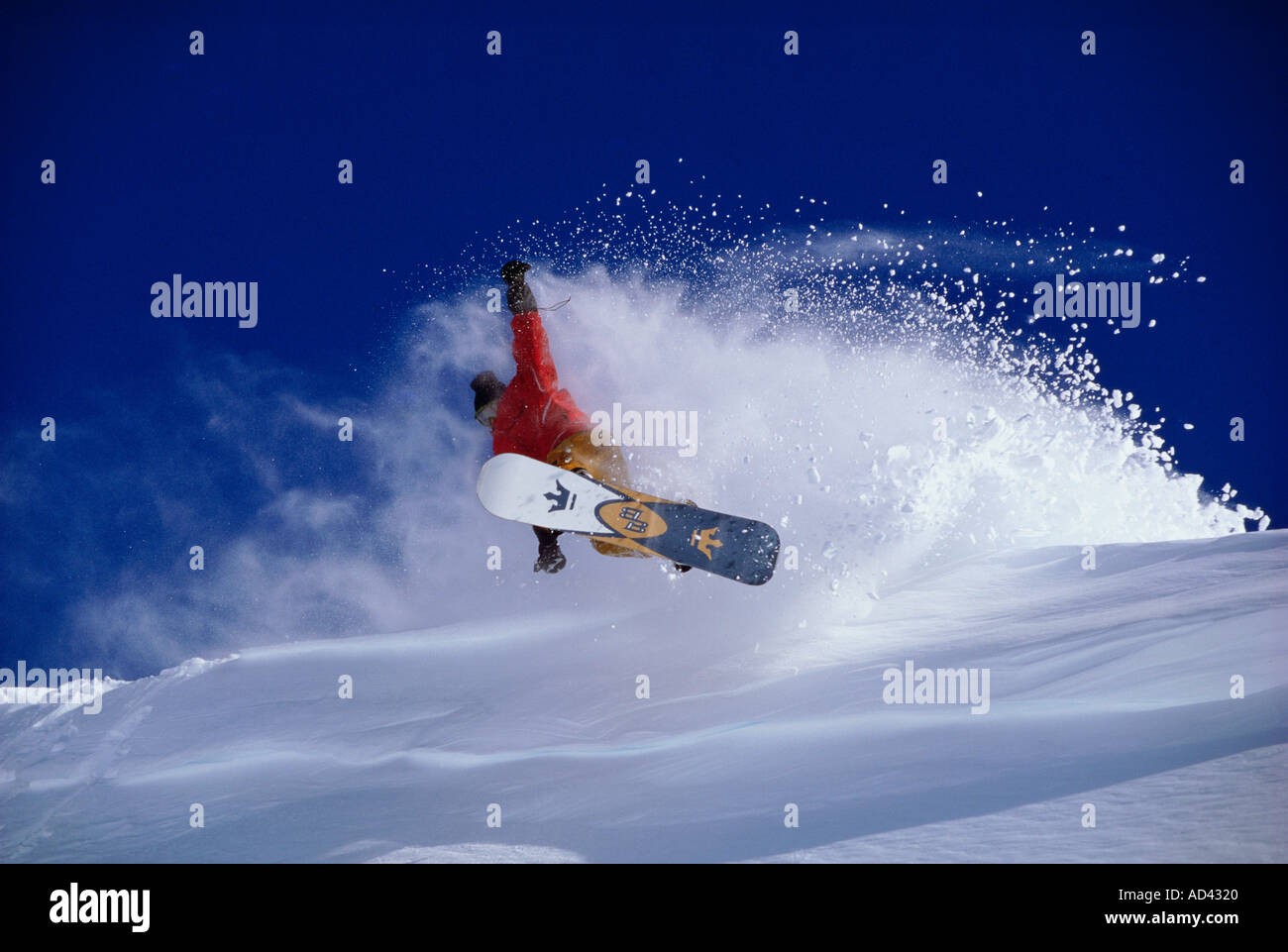 Snowboarder bursting through powder snow Location Generic Model release ...