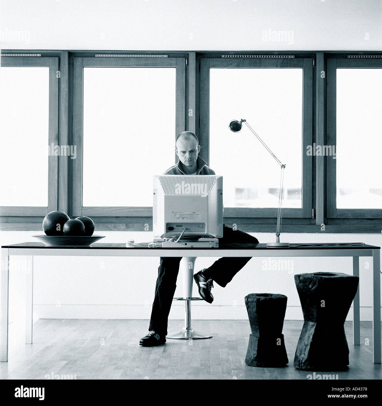 Guy at computer in penthouse Stock Photo - Alamy