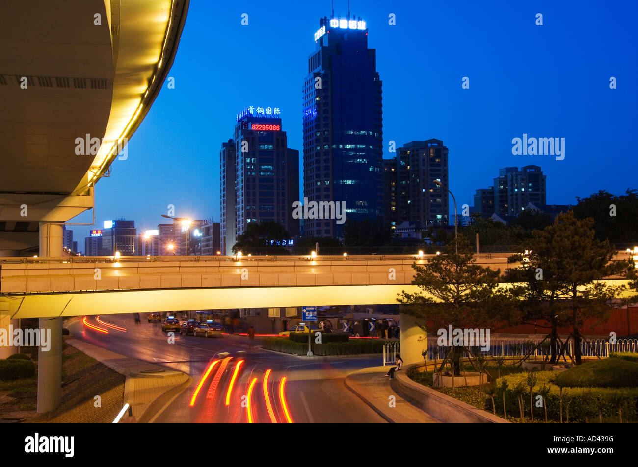 car light trails and modern buildings near Beijing North Train Station ...