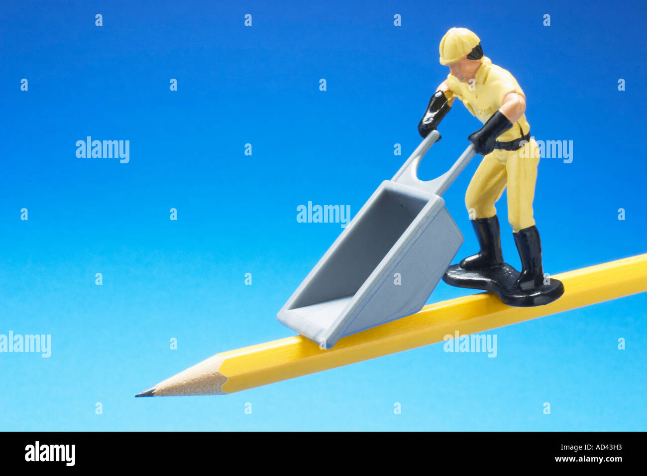 Miniature Workman Figurine on Pencil Stock Photo - Alamy