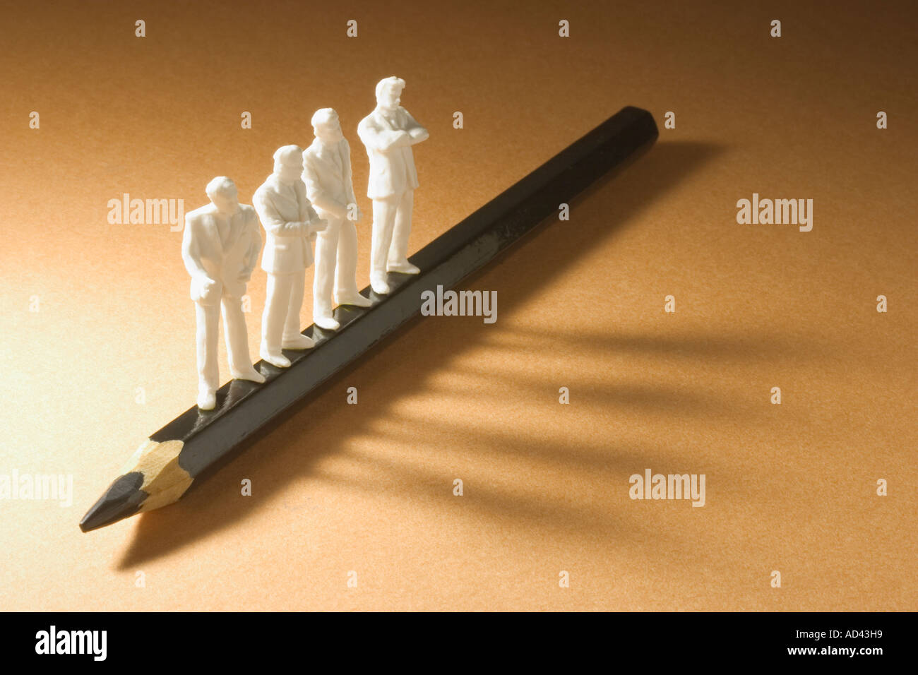 Businessman figures on pencil hi-res stock photography and images - Alamy