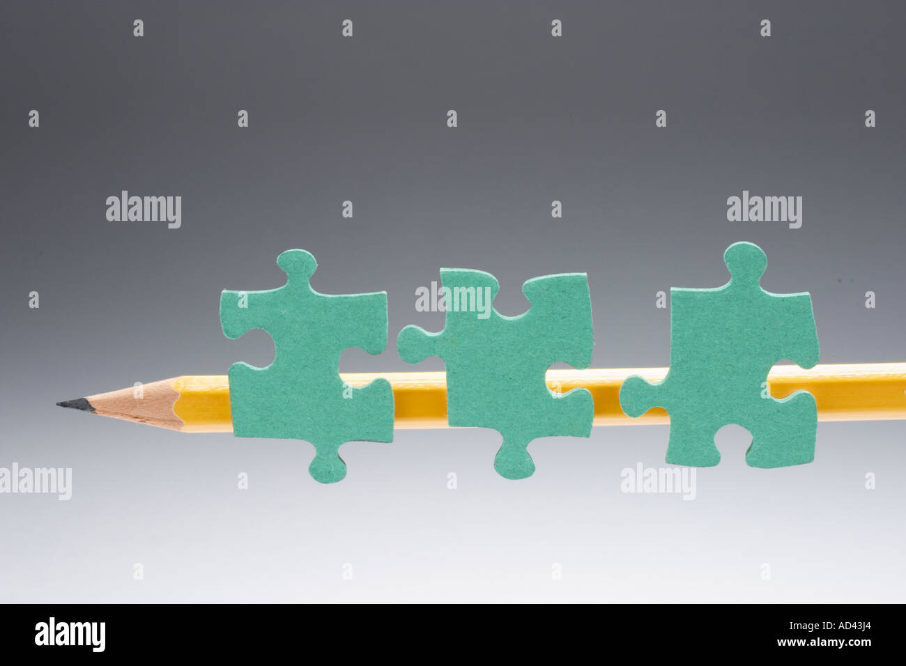 Pencil with Jigsaw Puzzle Pieces Stock Photo - Alamy