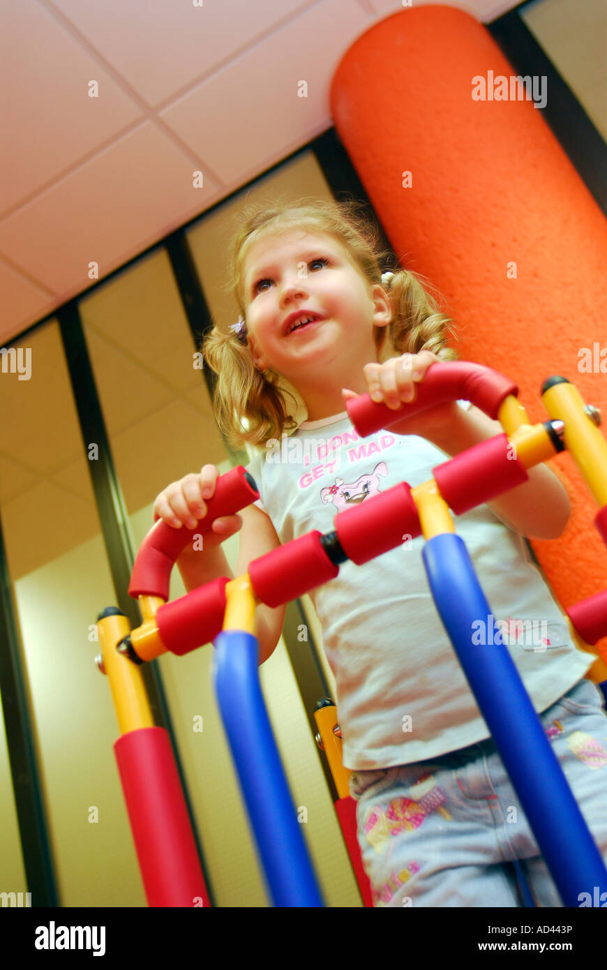 4 year old girl at a recreation centre using running machine in creche ...