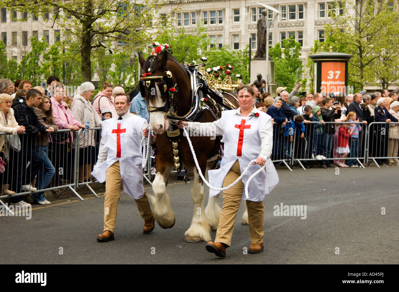 Man and a woman leading a horse in the St George Parade and festival ...