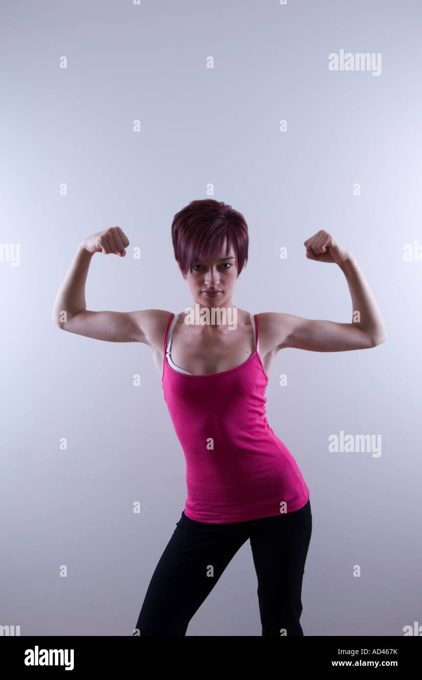 Strong woman flexing biceps Stock Photo - Alamy