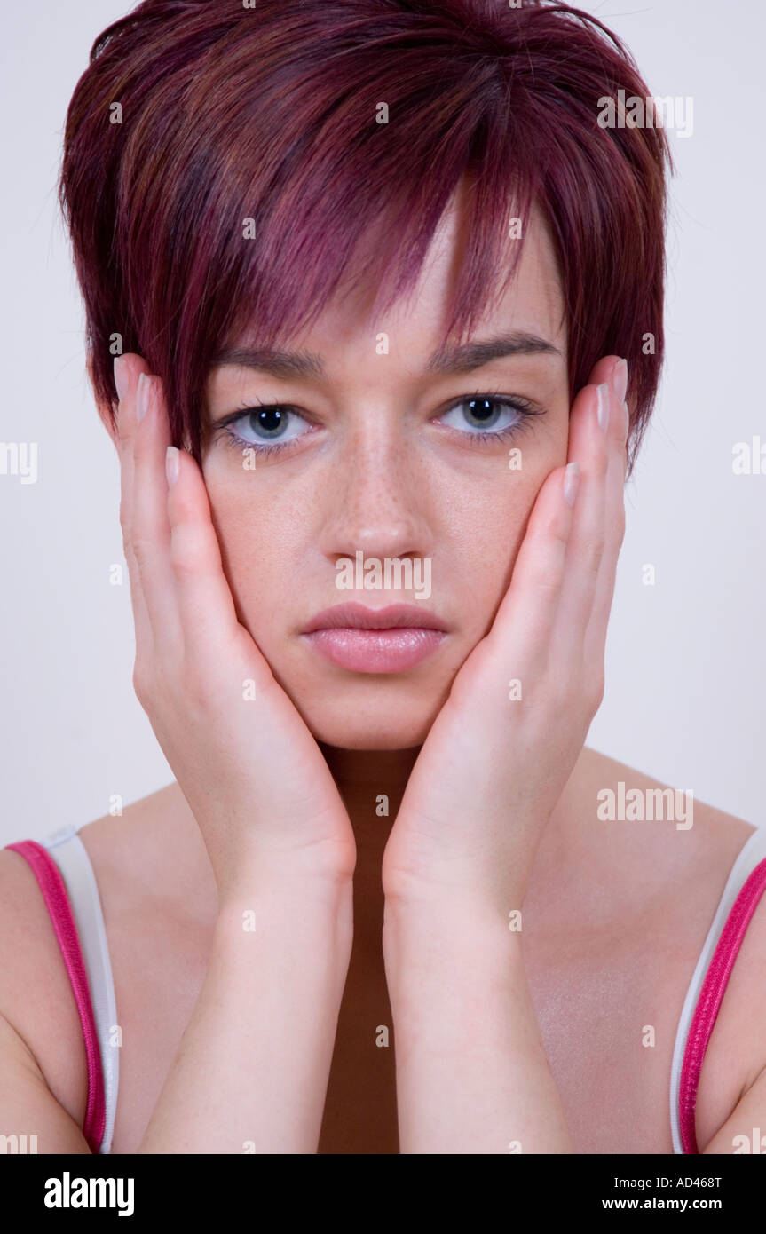 Sad young Caucasian woman hands on face Stock Photo - Alamy